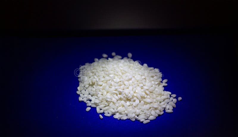Closeup View of Raw White Rice on Blue & Black Background Stock Photo ...