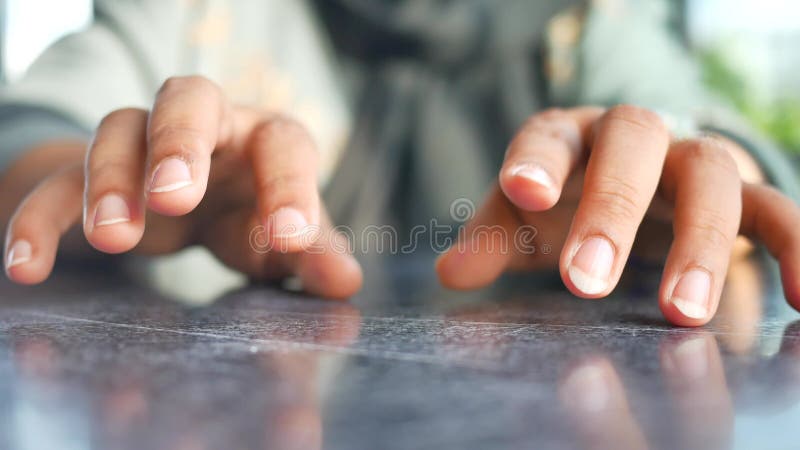 A Closeup View Showcasing Hands Resting Elegantly on the Smooth Surface ...