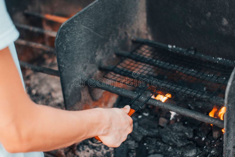 Closeup View of a Spanish Guy Cooking Meat on a Grill Mesh in a Park ...