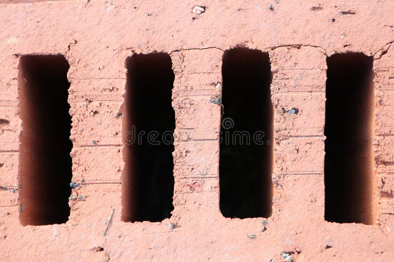 A Textured Brick Wall Featuring Vertical Openings Which Creates an ...