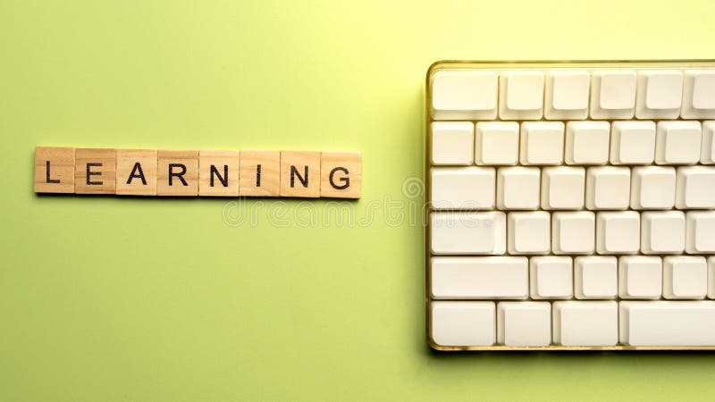 Closeup View of a Wooden Cube with Learning Word and Computer Keyboard ...