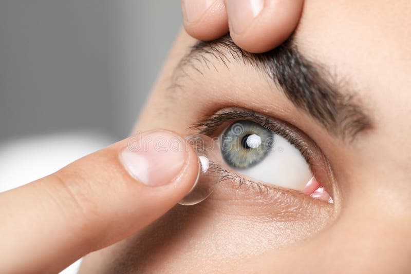 Closeup View of Young Man Putting in Contact Lens Stock Photo - Image ...