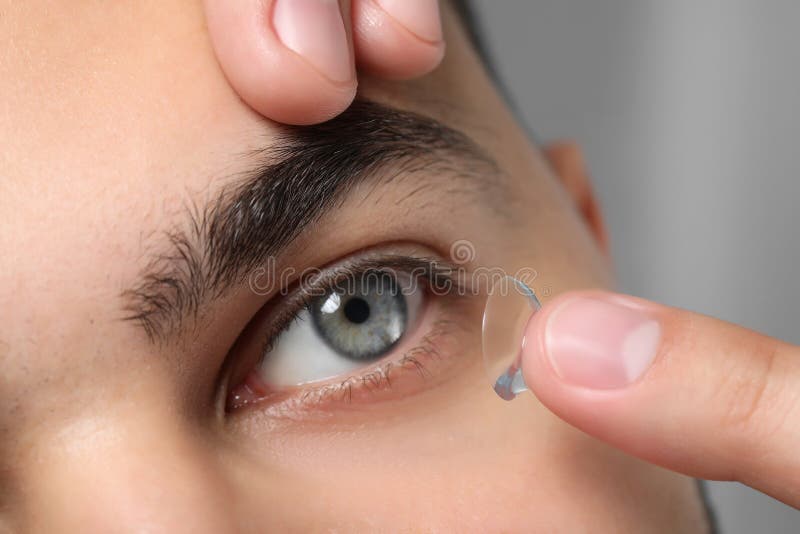 Closeup View of Young Man Putting in Contact Lens Stock Photo - Image ...