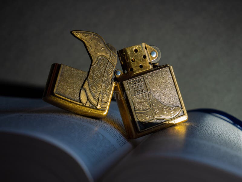 Closeup of a Vintage Lighter with a Boot Design on a Book Stock Image ...