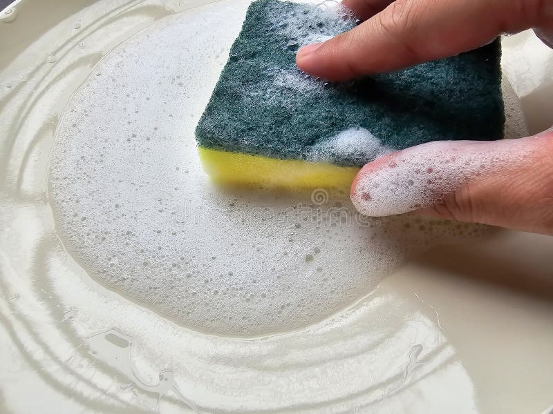 Closeup of Washing Dishes while Rubbing a Sponge on a Plate Stock Image ...