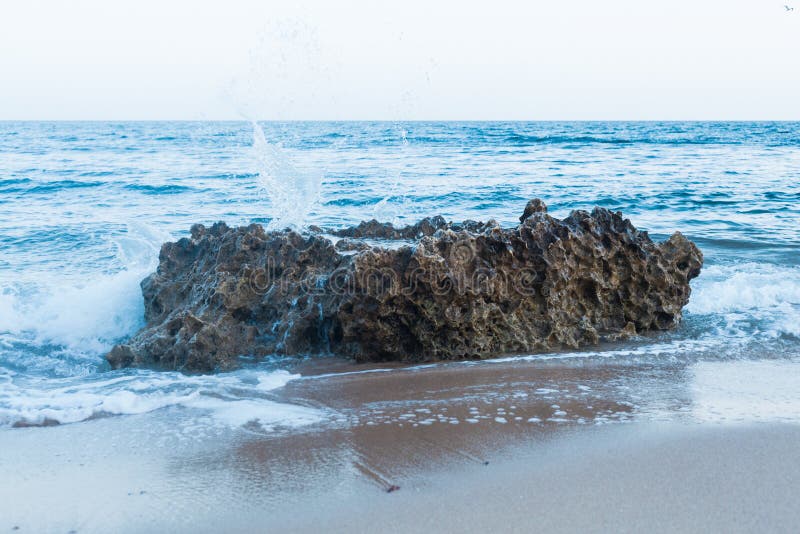 Closeup of Waves Hitting a Rock at a Shore Creating Water Splash and ...