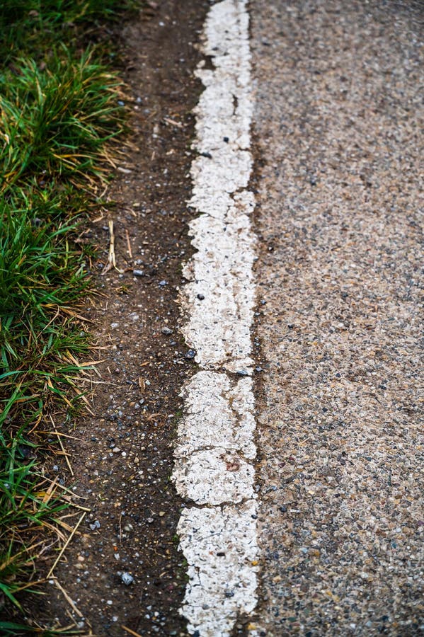 Closeup of the Weathered White Line on the Asphalt Road Surrounded by ...