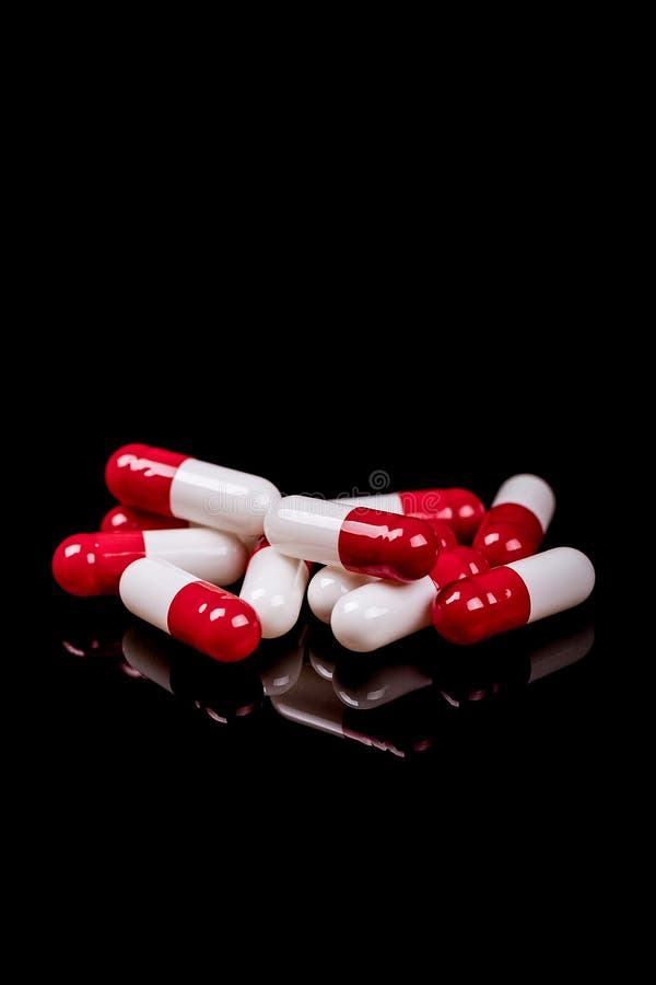 Closeup of White - Red Capsules Isolated on Black Background Stock ...