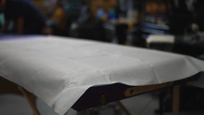 Closeup of the White Sheet on the Table in a Tattoo Studio. Stock ...
