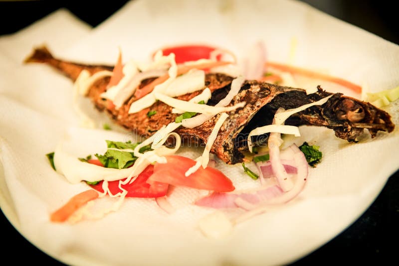 Closeup Whole Fried Fish Served with Sliced Assorted Vegetables on ...