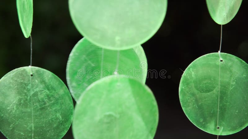 Closeup of a Wind Chime Mobile with Green Capiz Shells Stock Video ...