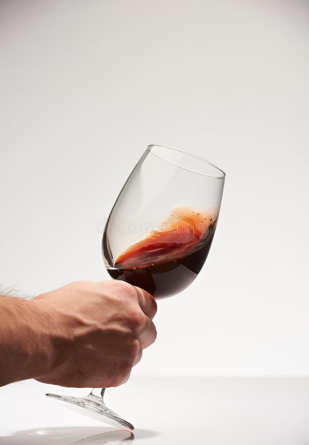Hand Shaking Glass with Red Wine Stock Photo - Image of celebration ...