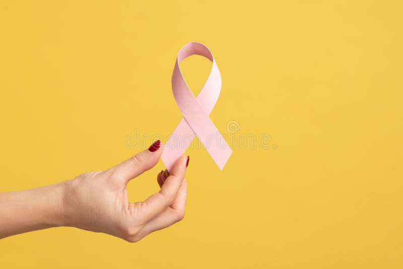 Closeup Of Woman Hand With Manicure Holding Pink Ribbon Symbol Of