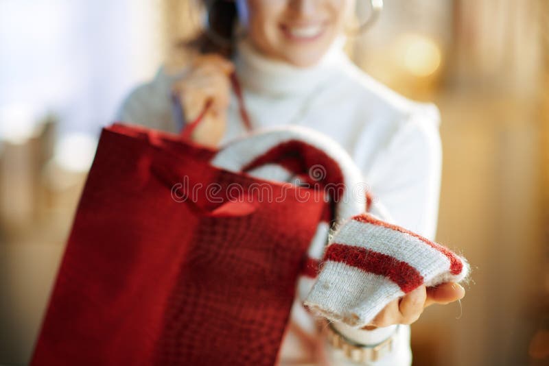 Closeup On Woman With Shopping Bag Checking Purchased Sweater Stock