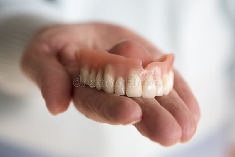 Closeup of Womans Hand Holding a Teeth Denture Stock Image - Image of ...