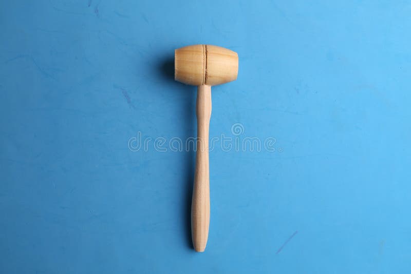 Closeup of a Wooden Mallet on a Blue Background Stock Photo - Image of ...