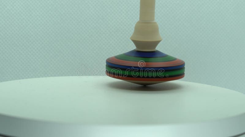 Closeup of a Wooden Spinning Top in Action on a White Base Stock ...