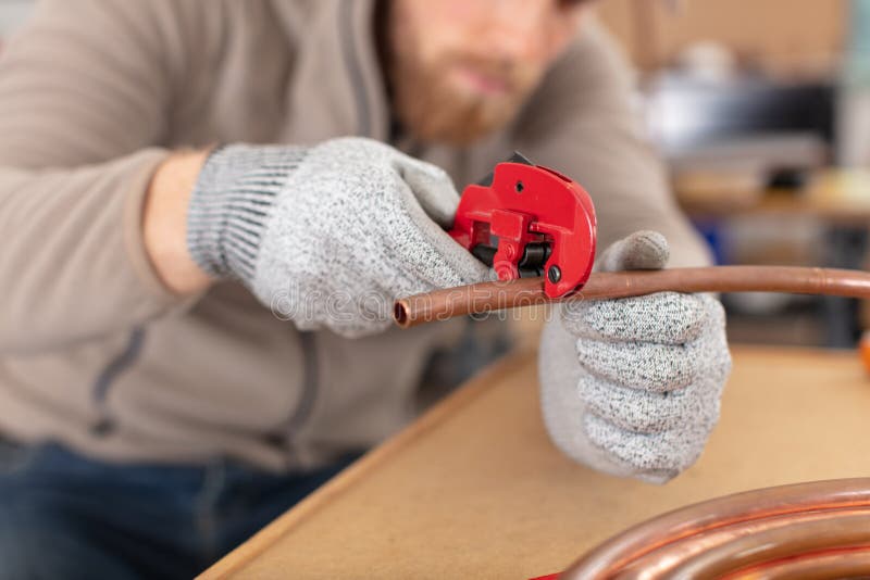 Closeup Worker Cutting Copper Pipe Stock Photo - Image of blue ...