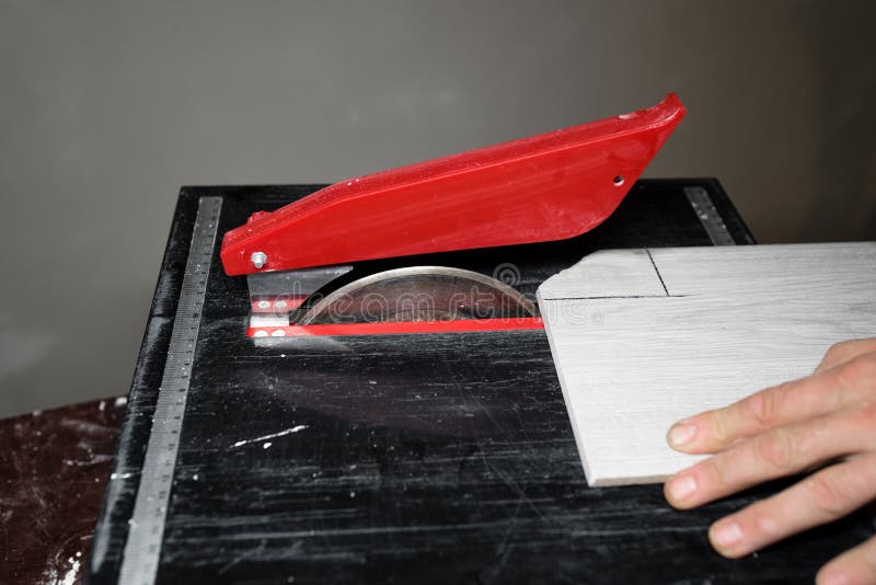 Marking the Tiles with a Yellow Ruler and a Pencil for Cutting with an ...