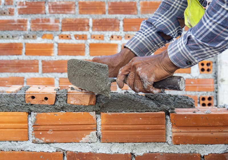 Masonry Work, Worker Laying Brick of an Office Building. Architectural ...