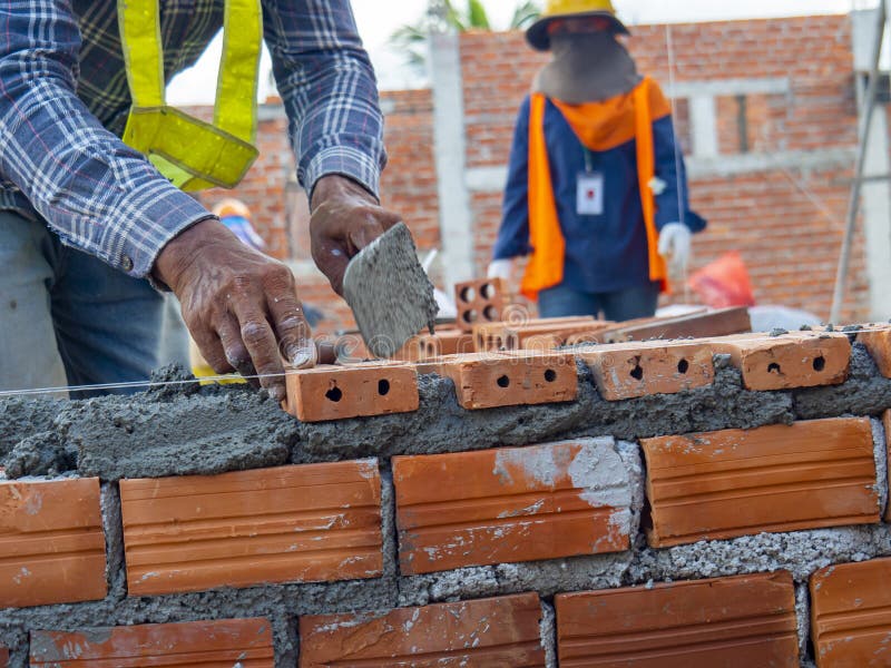 Masonry Work, Worker Laying Brick of an Office Building. Architectural ...