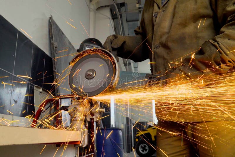 Closeup of Worker Using a Grinder Cuts Metal in a Workshop Stock Photo ...