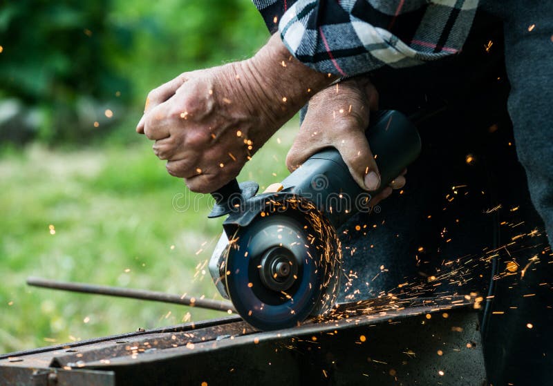 Closeup of Worker Using a Grinder on a Metal Plate Stock Image - Image ...