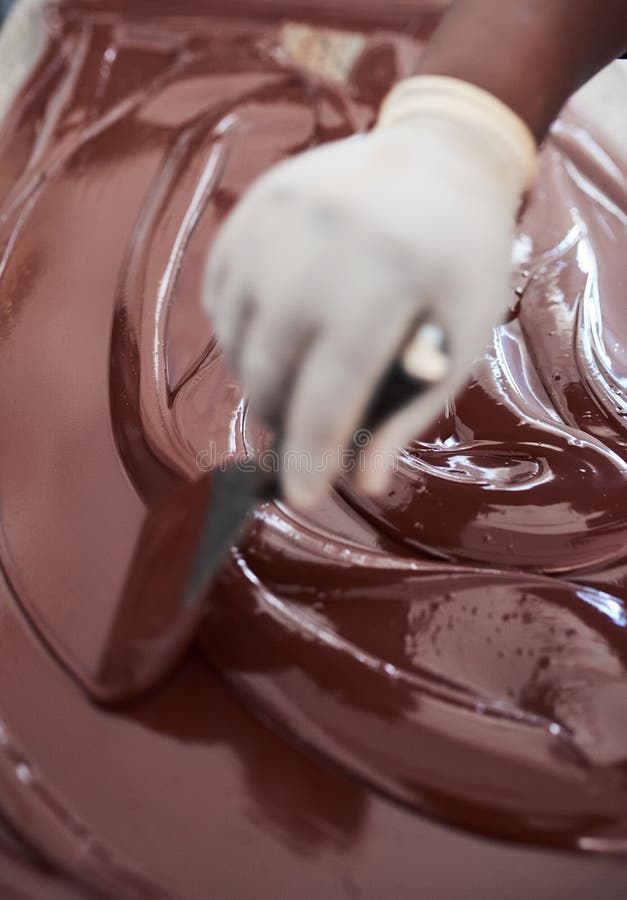 Confectionary Factory Worker Mixing Melted Chocolate with a Spatula ...