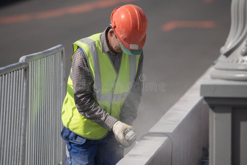 Closeup of a Worker Who Processes Granite Using a Grinding Machine ...