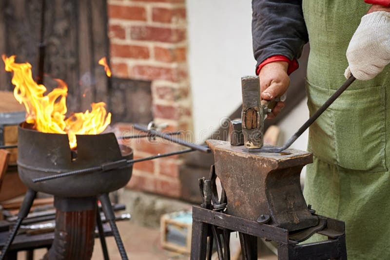 Blacksmith Working In Workshop Stock Image - Image of holding ...
