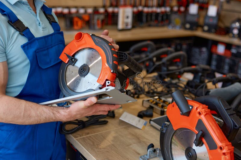 Closeup Workman Holding Circular Saw in Hands Choosing New Electric ...