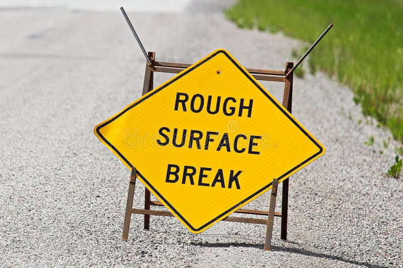 Closeup of a Yellow Rough Surface Break Sign on Pavement Stock Image ...