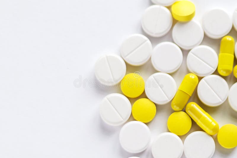 Closeup of Yellow and White Tablets on White Background Stock Image ...