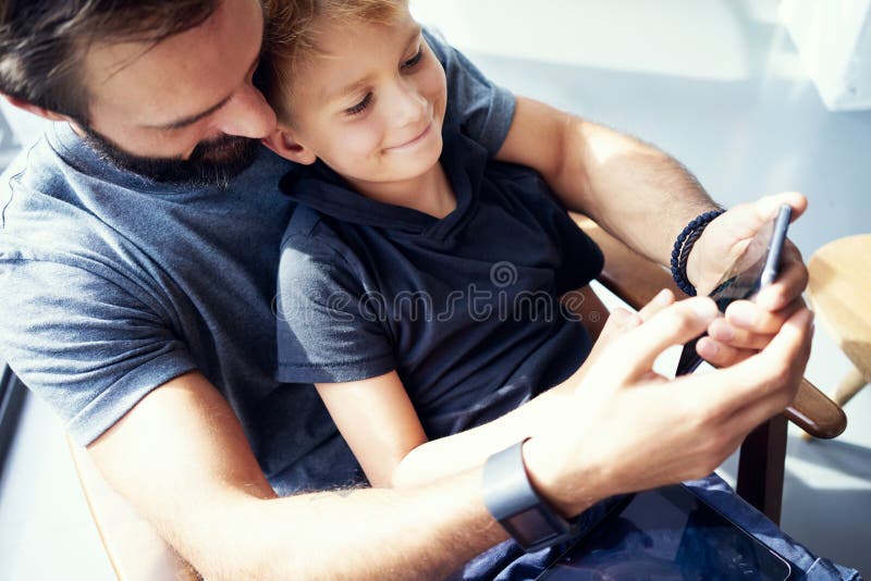 Father and Son Using Laptop Sitting on Sofa Stock Image - Image of ...