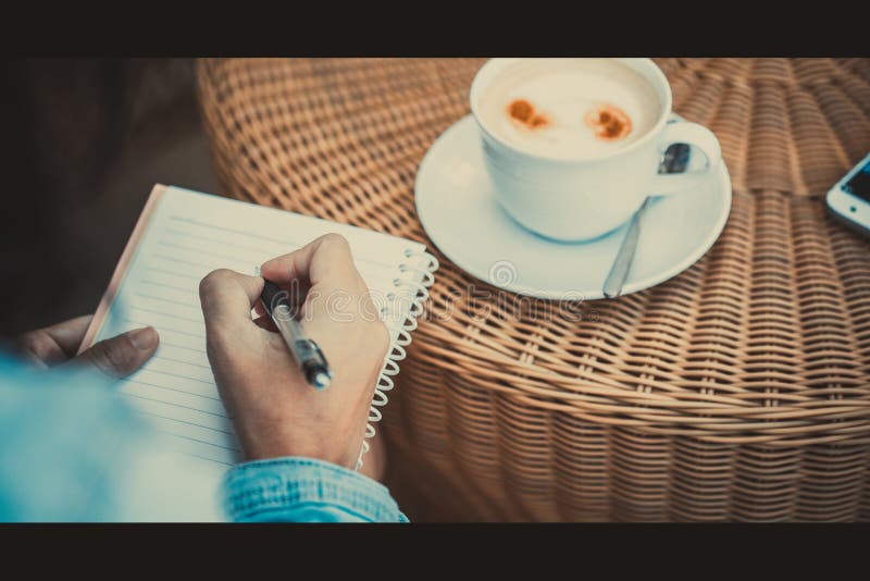 Closeup of a Young Business Woman Write a Book for Work and Drinking ...