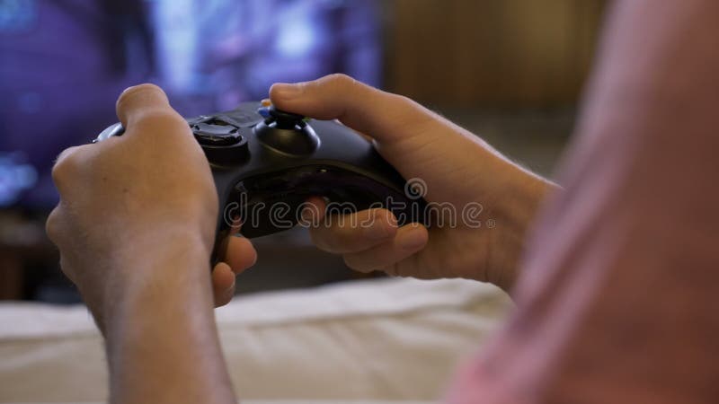 Closeup of Young Man Hands Using Joystick Playing Video Games on Large ...