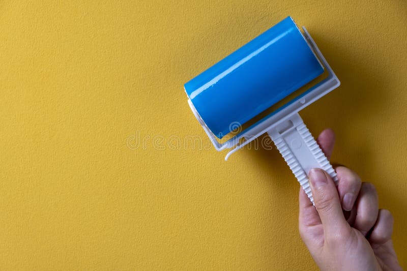 Cloth Fabrics Cleaner Lint Roller Brush on Yellow Background. Stock ...