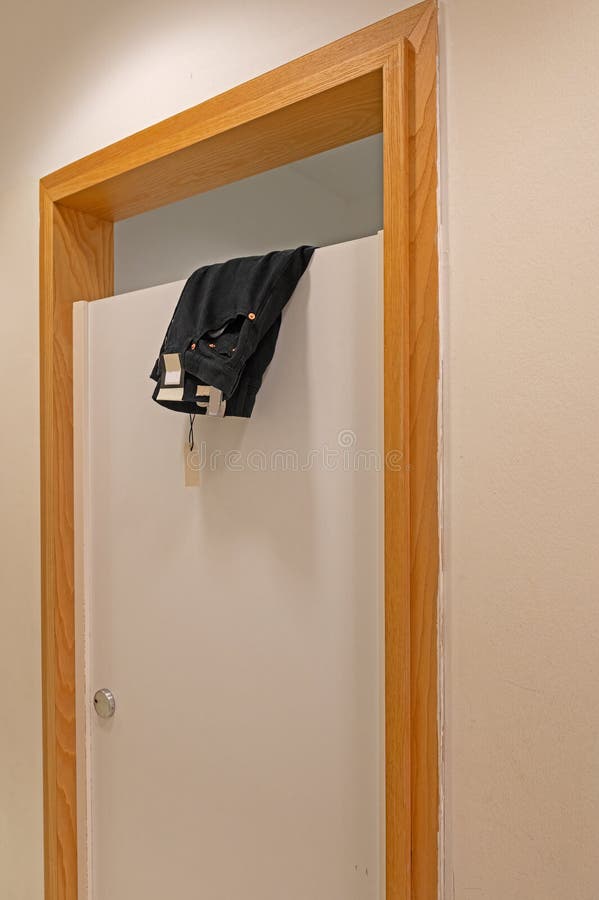 Clothes at the Door of the Fitting Room in the Shop Stock Image - Image ...