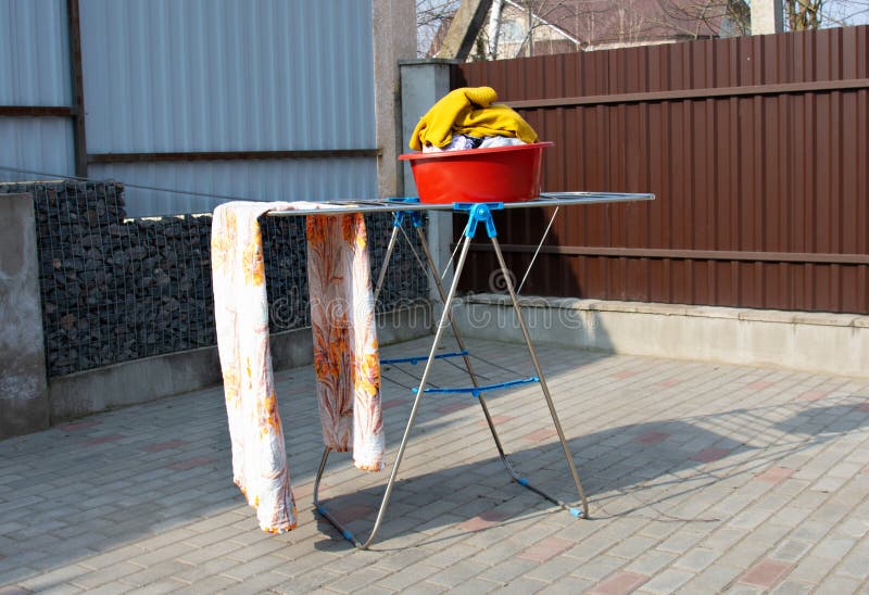 Clothes Dryer Stands Outdoors with Laundry in a Basin Stock Photo ...