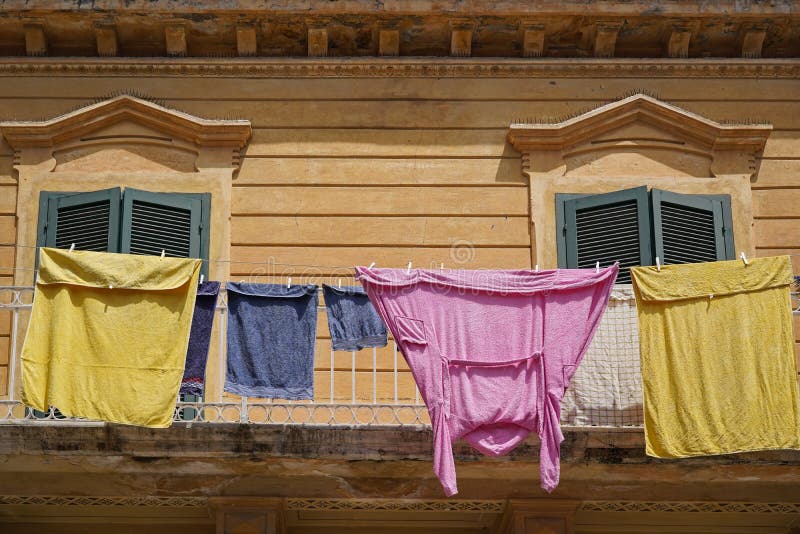 Clothes drying in the sun stock photo. Image of city - 224194556
