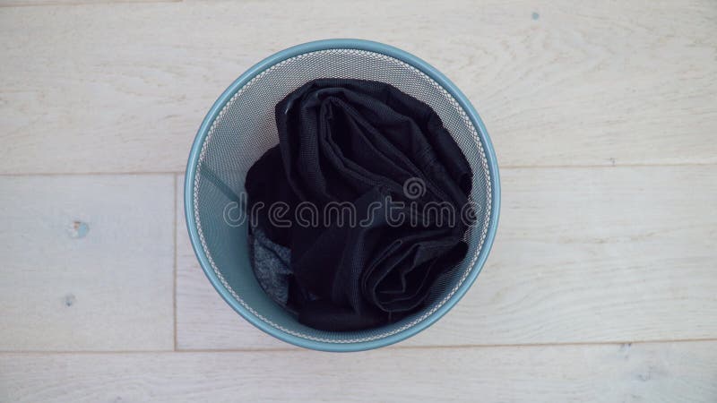 Clothes Fall into an Empty Trash Can. Garbage Sorting. Recycling. the ...