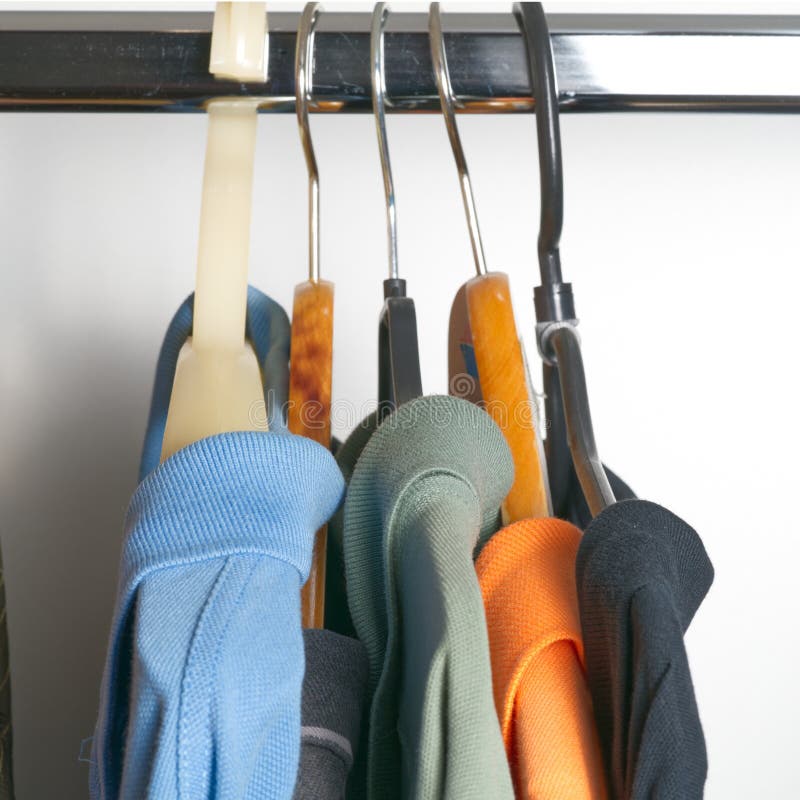 Clothes Hang on Hangers Inside the Closet. Close Stock Image - Image of ...