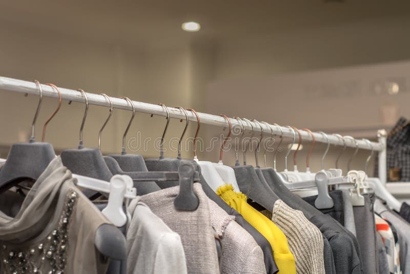Clothes Hang on a Shelf in a Clothes Store Stock Image - Image of ...
