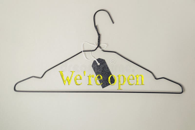 Clothes Hanger with a Tag on it that Says we Re Open Stock Photo ...