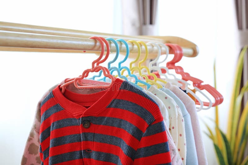 Clothes with Hangers Hang on a Wood Rack in House Stock Image - Image ...