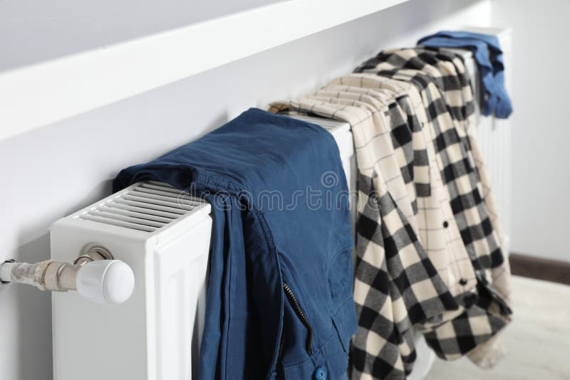 Clothes Hanging on White Radiator in Room Stock Photo - Image of ...