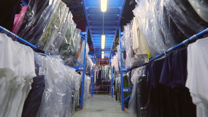 Clothes in the Warehouse of the Factory. Industrial Interior. Warehouse ...