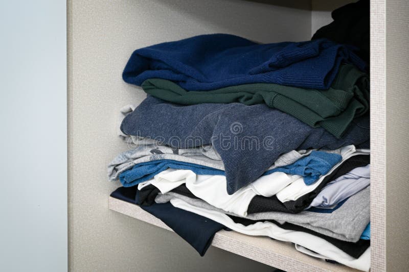 Clothes Messy Piled Up on the Closet Shelf Stock Photo - Image of ...