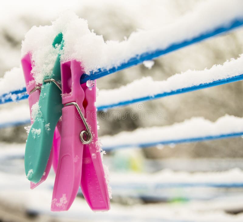 Clothes Pegs on Washing Line Under Snow Stock Photo - Image of ...