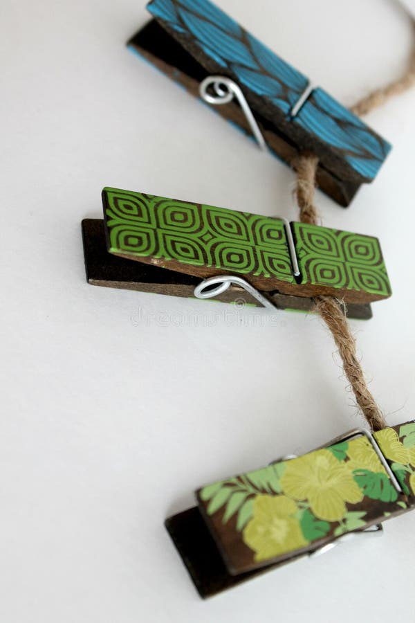 Decorative Wooden Clothes Pins with Patterns Hanging on Twine Stock ...